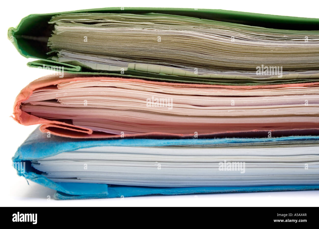 Red, green and blue binder full of documents. Isolated on a white ...