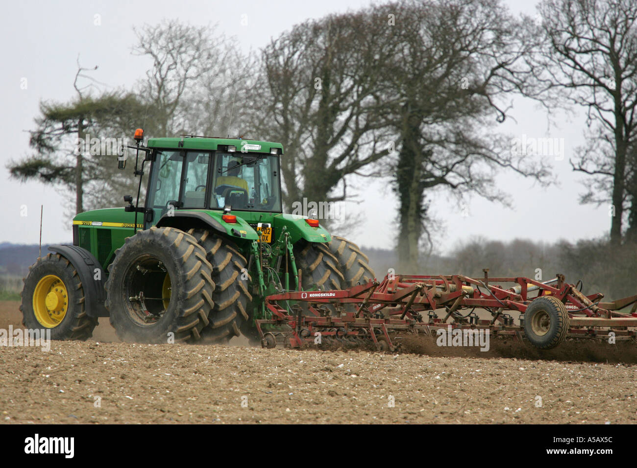 Iconic image of British farming as a modern tractor ploughs an arable ...