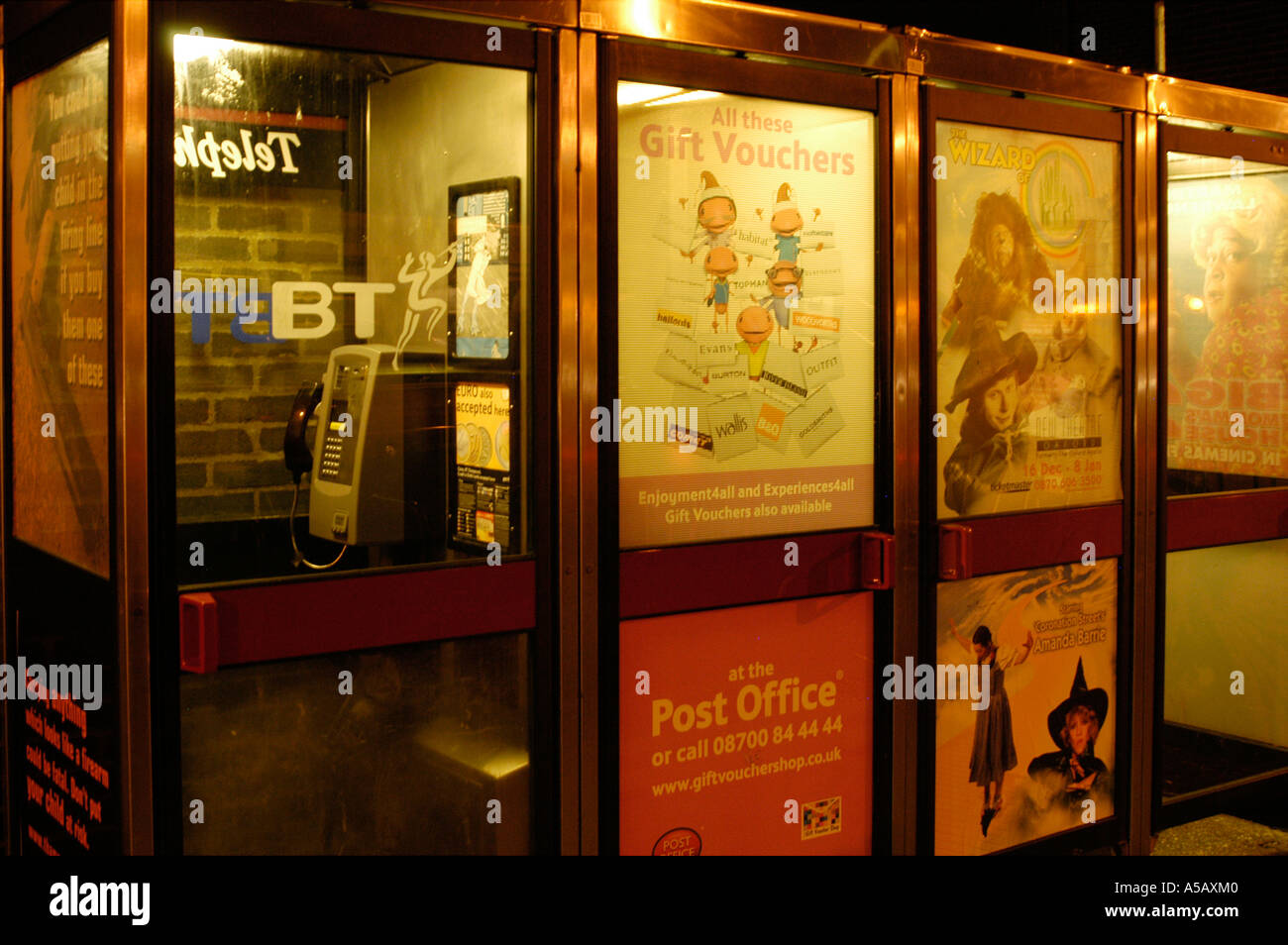 Modern BT telephone boxes seen at night Stock Photo - Alamy