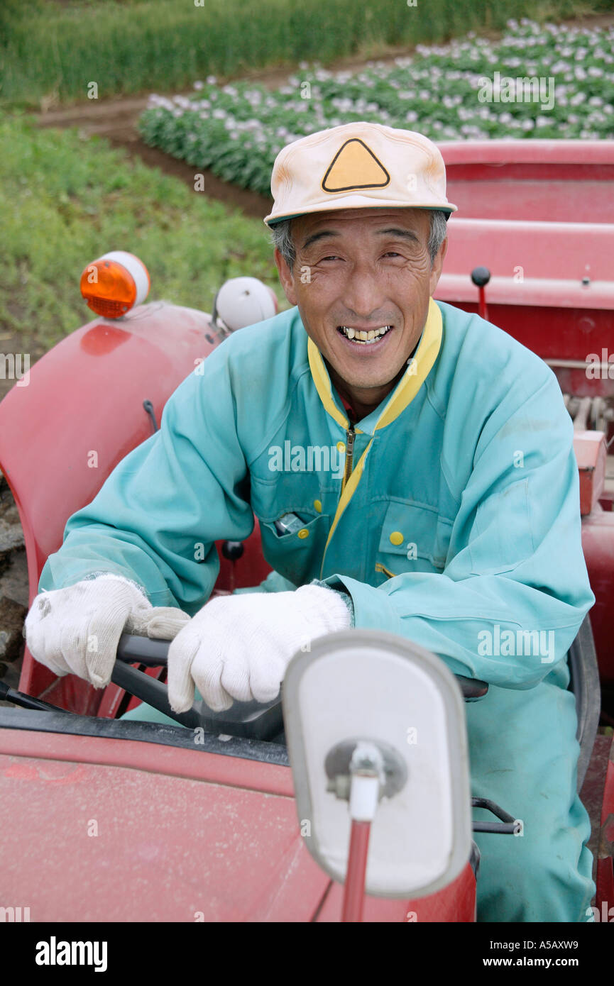 A farmer sitting in a tractor Stock Photo - Alamy