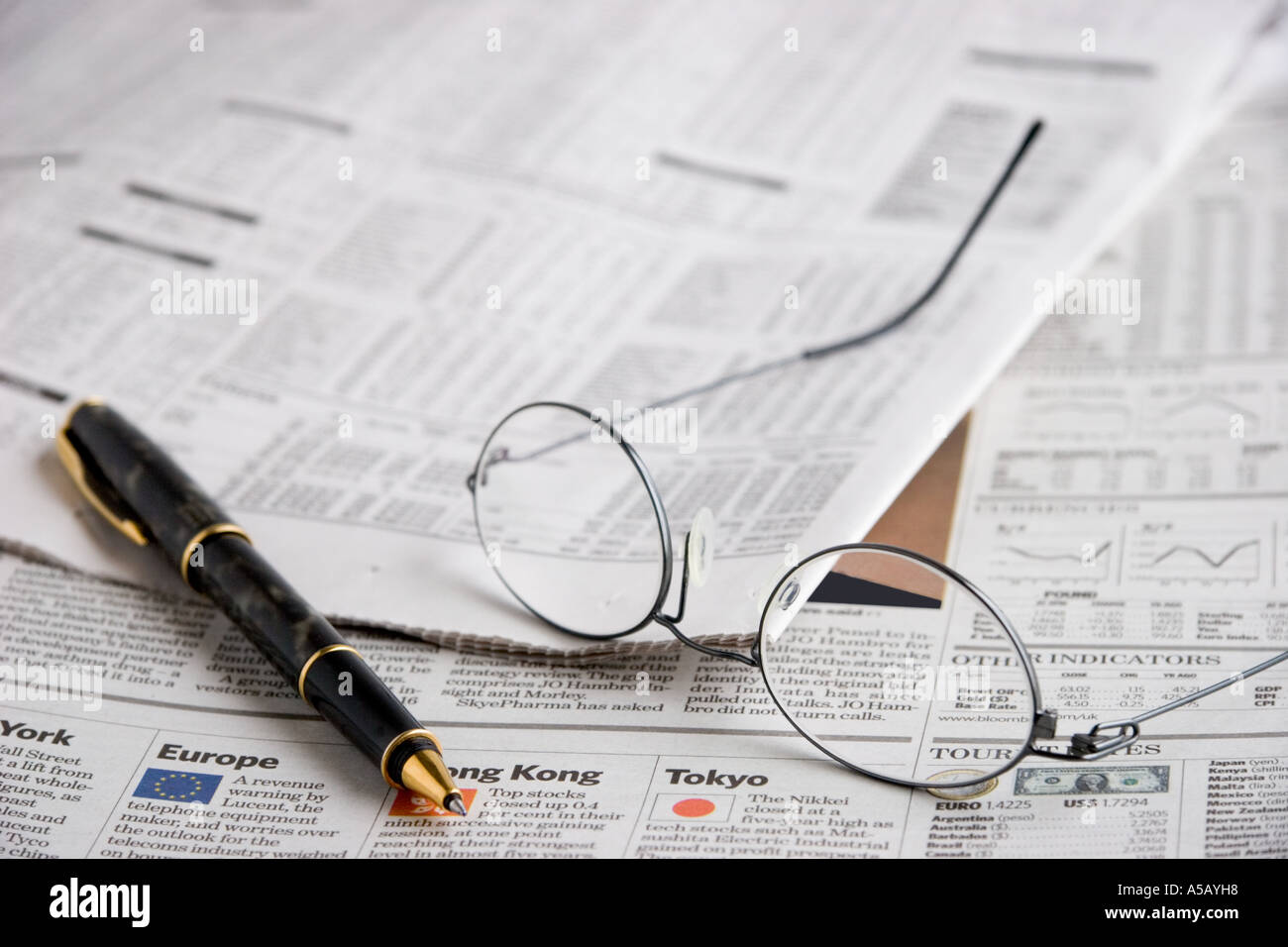 Financial newspaper pen and glasses Stock Photo - Alamy