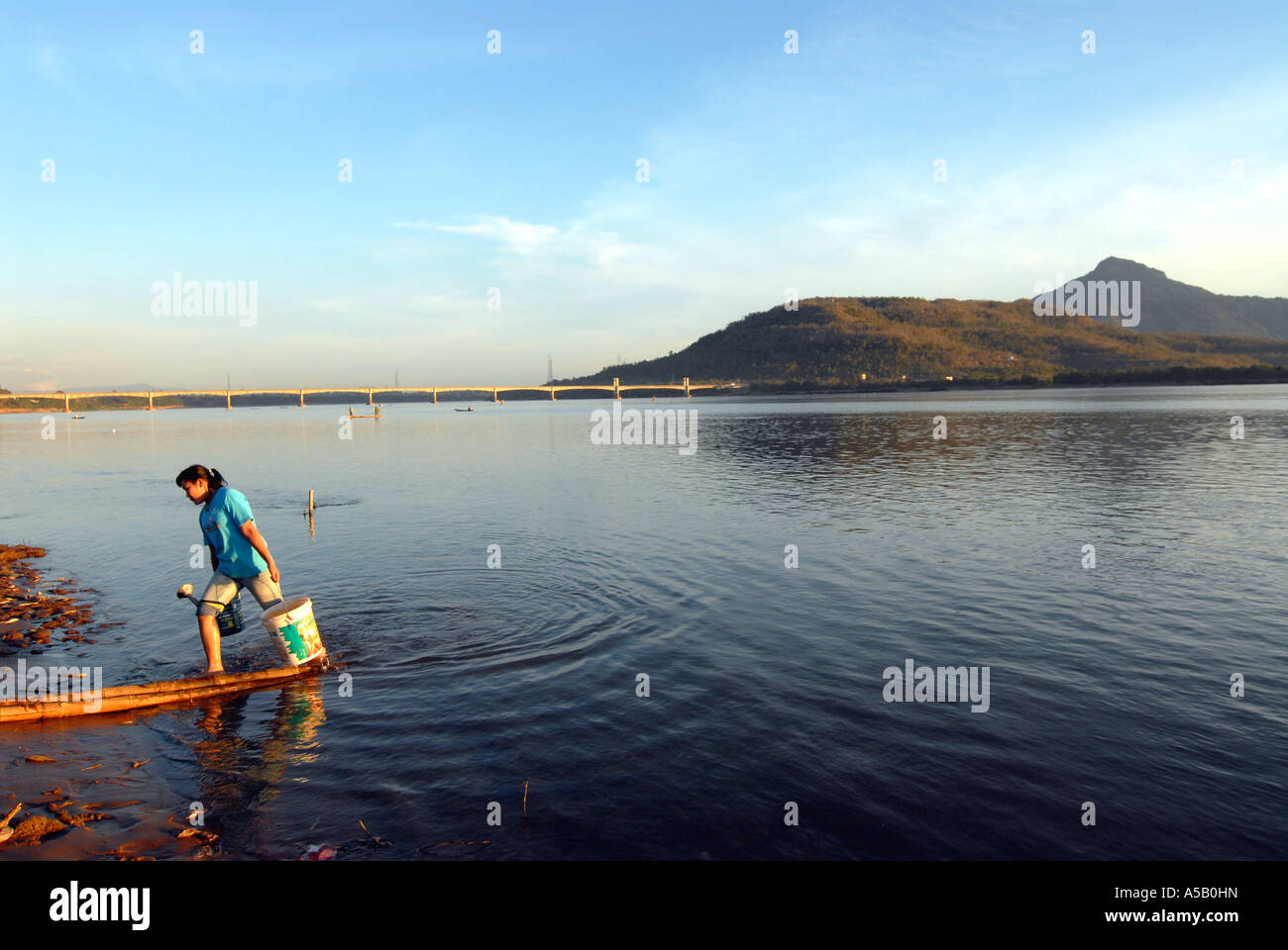 Woman fetching water from the river hi-res stock photography and images ...