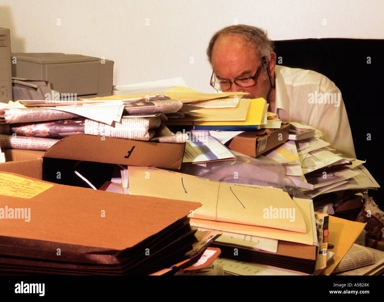 Businessman with pile of papers hi-res stock photography and images - Alamy