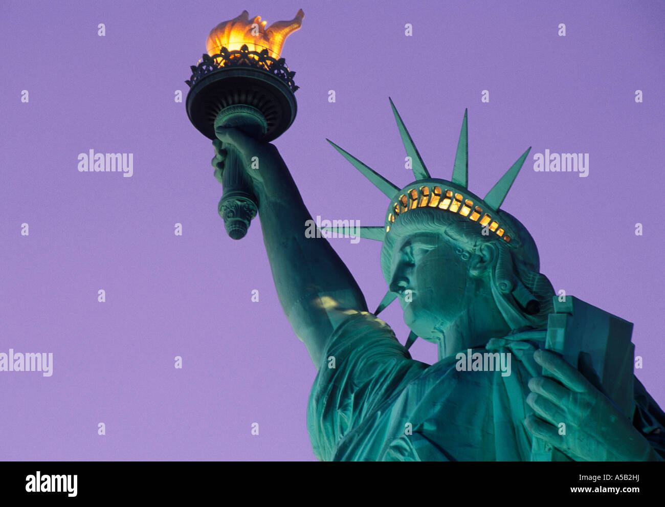 Statue of Liberty illuminated dusk or nightfall or twilight. Upper body ...