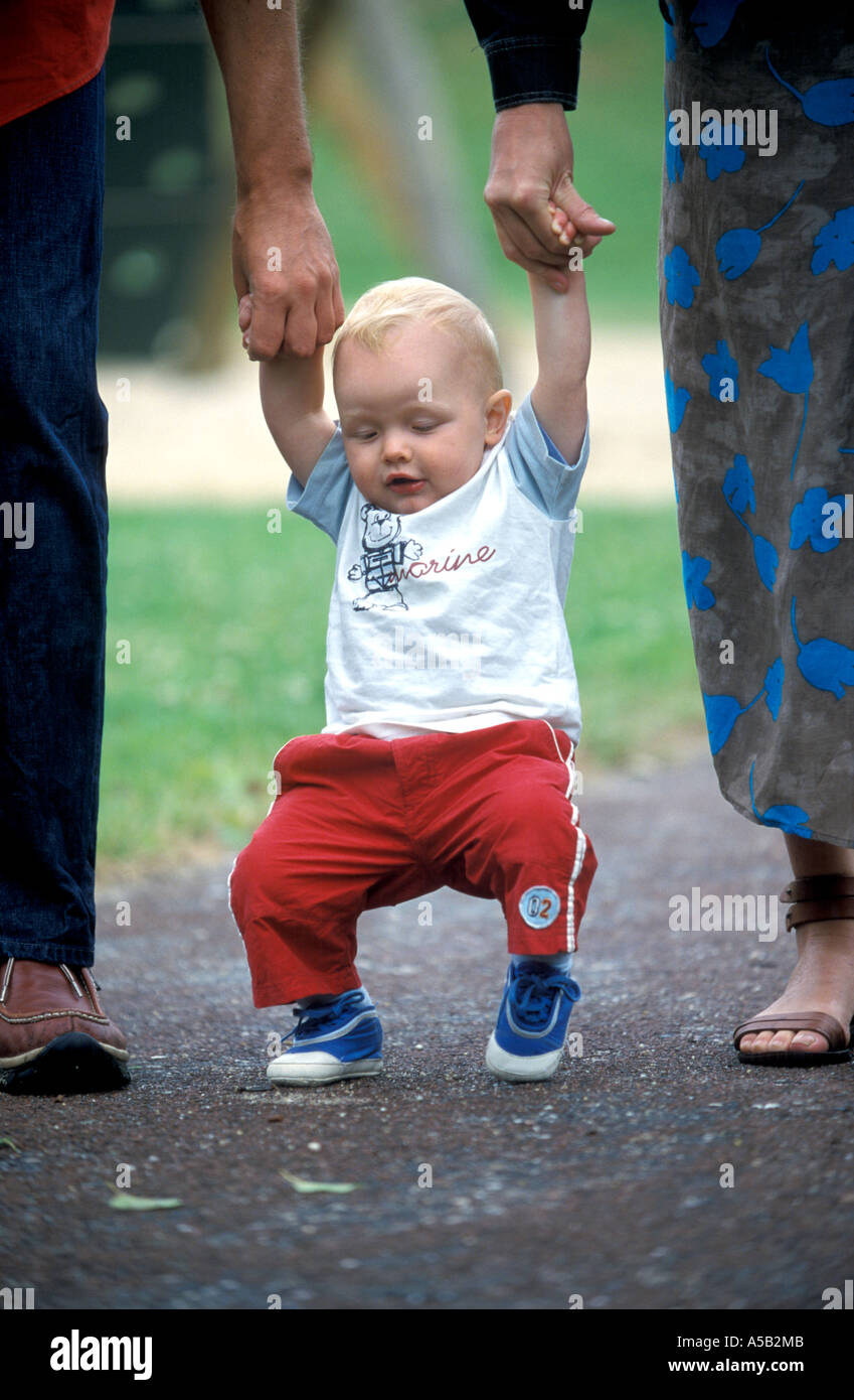 Little baby boy is trying to walk Stock Photo - Alamy