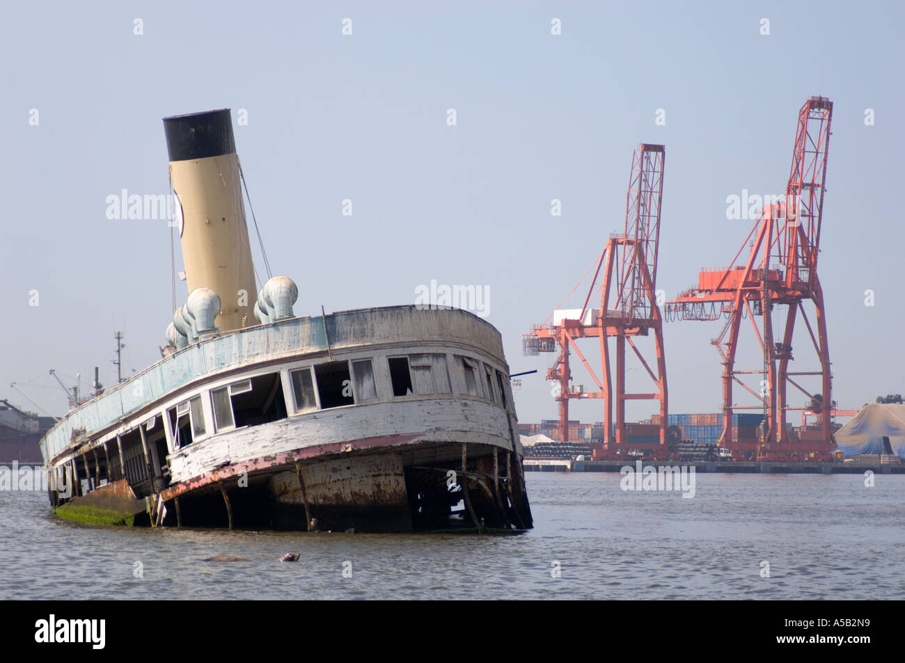 Sunken Ferry with Container Ship Crains Stock Photo - Alamy