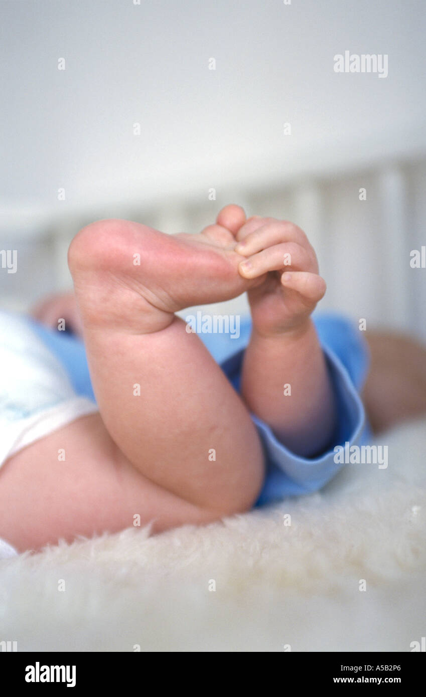 Baby hand holding baby foot Stock Photo - Alamy
