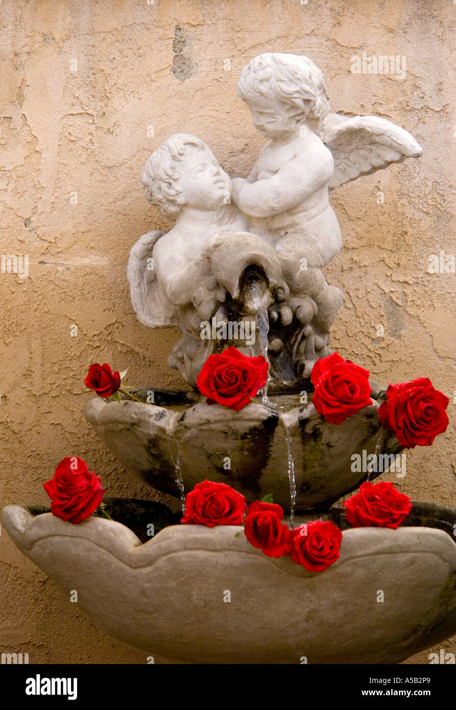Fountain with Red Roses Stock Photo - Alamy