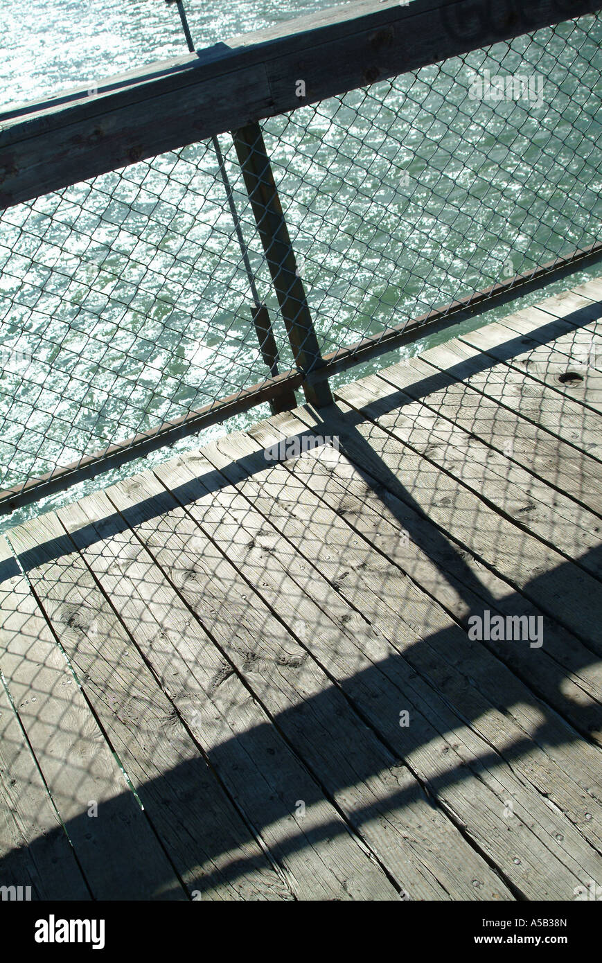 Bridge railing detail with shadows on decking Stock Photo - Alamy