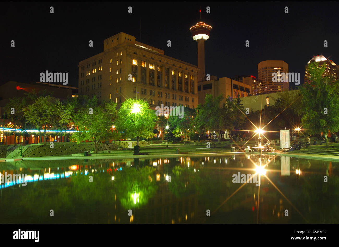 Calgary Tower reflecting in water at night Stock Photo - Alamy