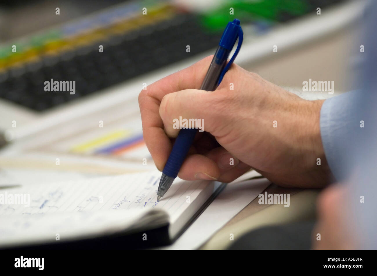 Financial analyst writing notes Stock Photo - Alamy