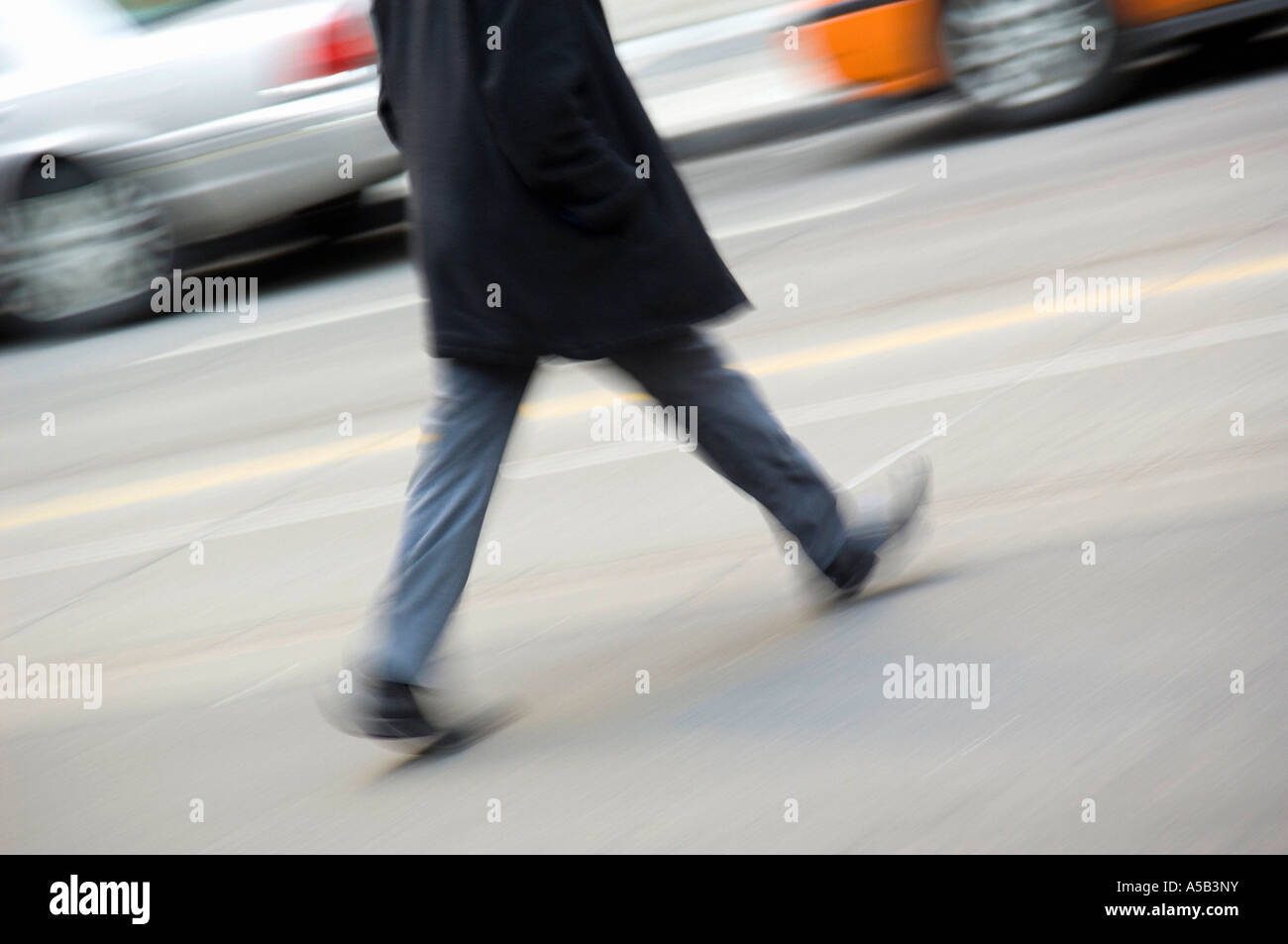 Person walking quickly across busy road Stock Photo - Alamy