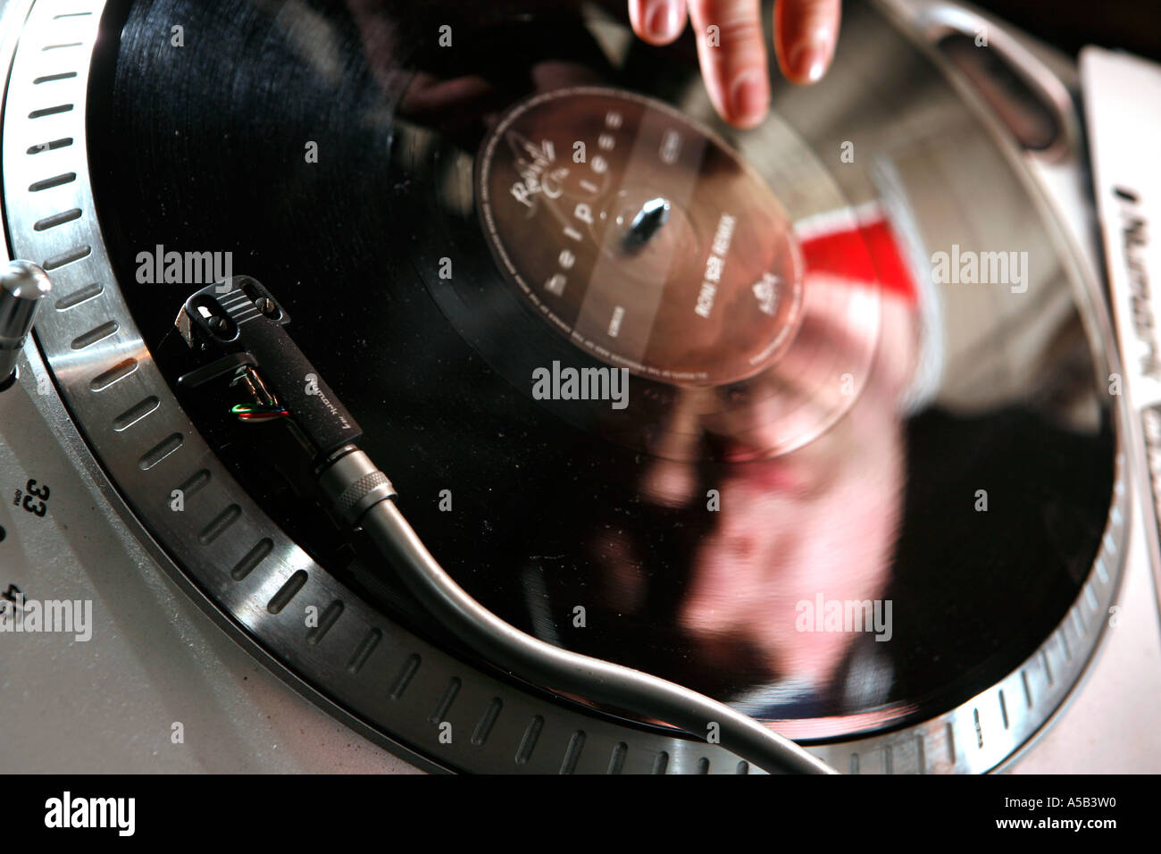 Dj scratching a record on a turntable hi-res stock photography and ...