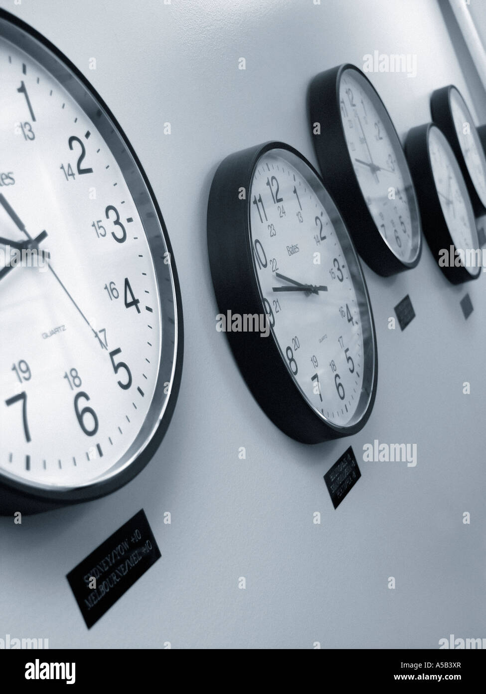 Row of clocks displaying different time zones Stock Photo - Alamy