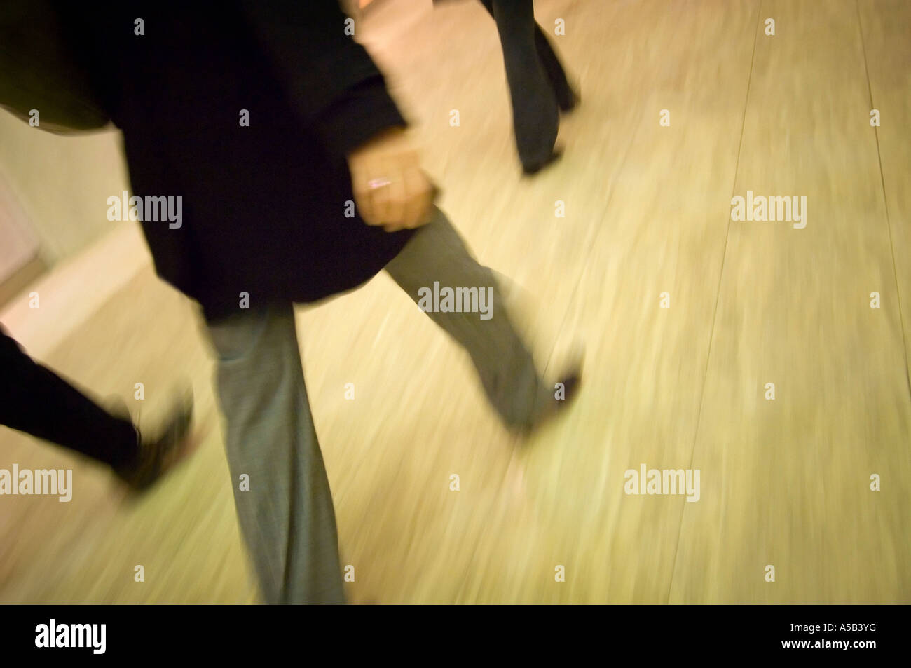 Business people walking quickly indoors Stock Photo - Alamy
