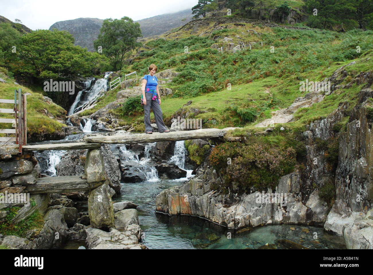 Woman standing on a primitive stone bridge Stock Photo - Alamy