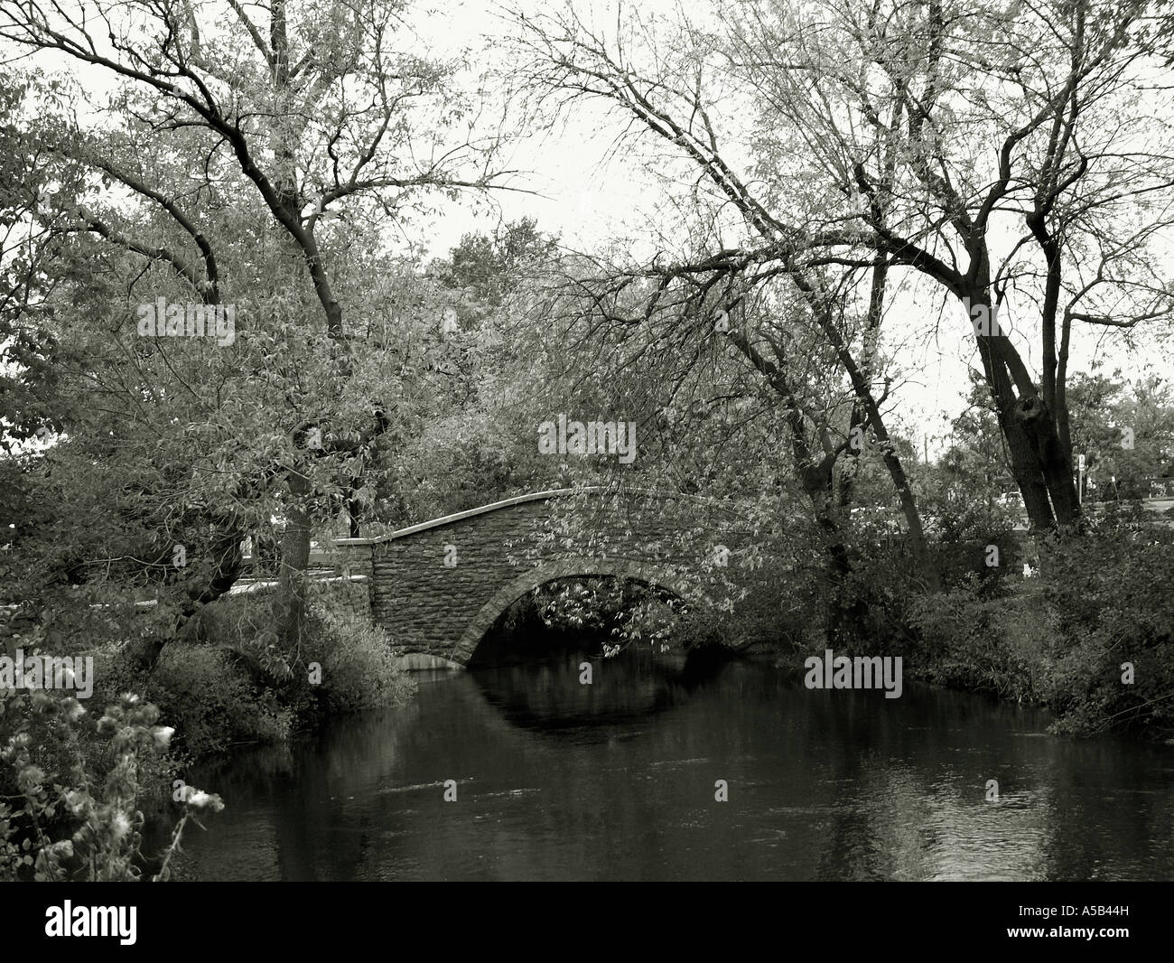 Stone bridge over small stream Stock Photo - Alamy