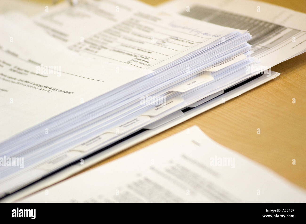 Binder with papers on office desk Stock Photo - Alamy
