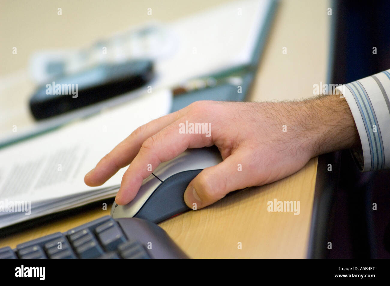 Man using mouse at desktop Stock Photo - Alamy