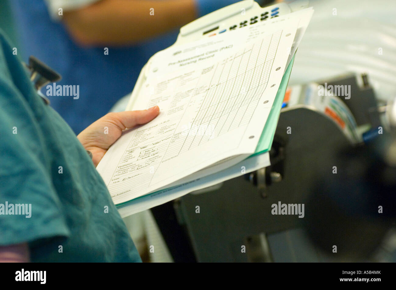 Surgeon holding hospital chart Stock Photo - Alamy
