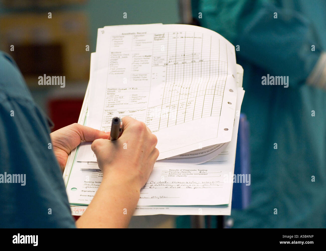 Surgeon's nurse's hands holding patient chart Stock Photo - Alamy