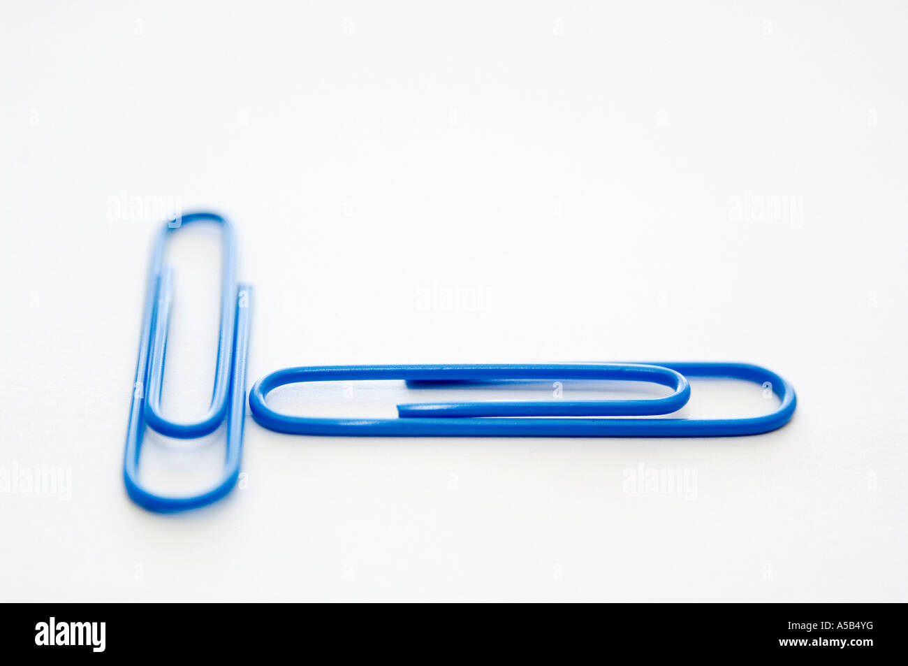 Two blue paper clips perpendicular to each other Stock Photo - Alamy