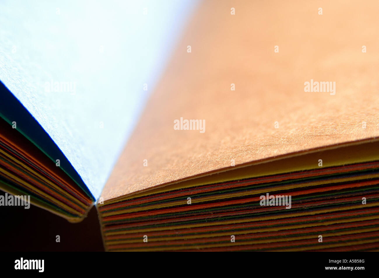 Assorted blank pages of colored paper in book Stock Photo - Alamy
