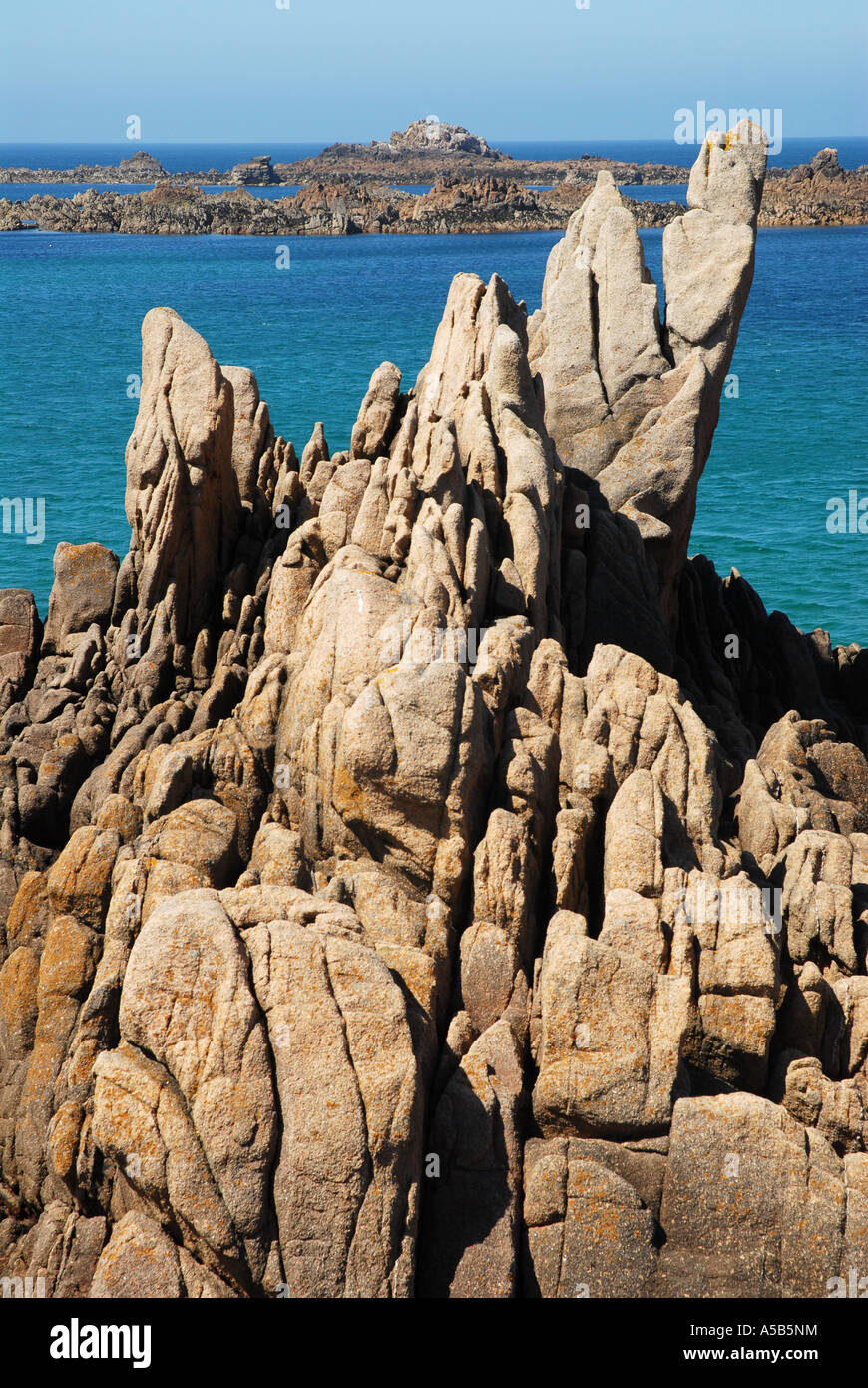Warm Rocks and Blue Sea Stock Photo - Alamy