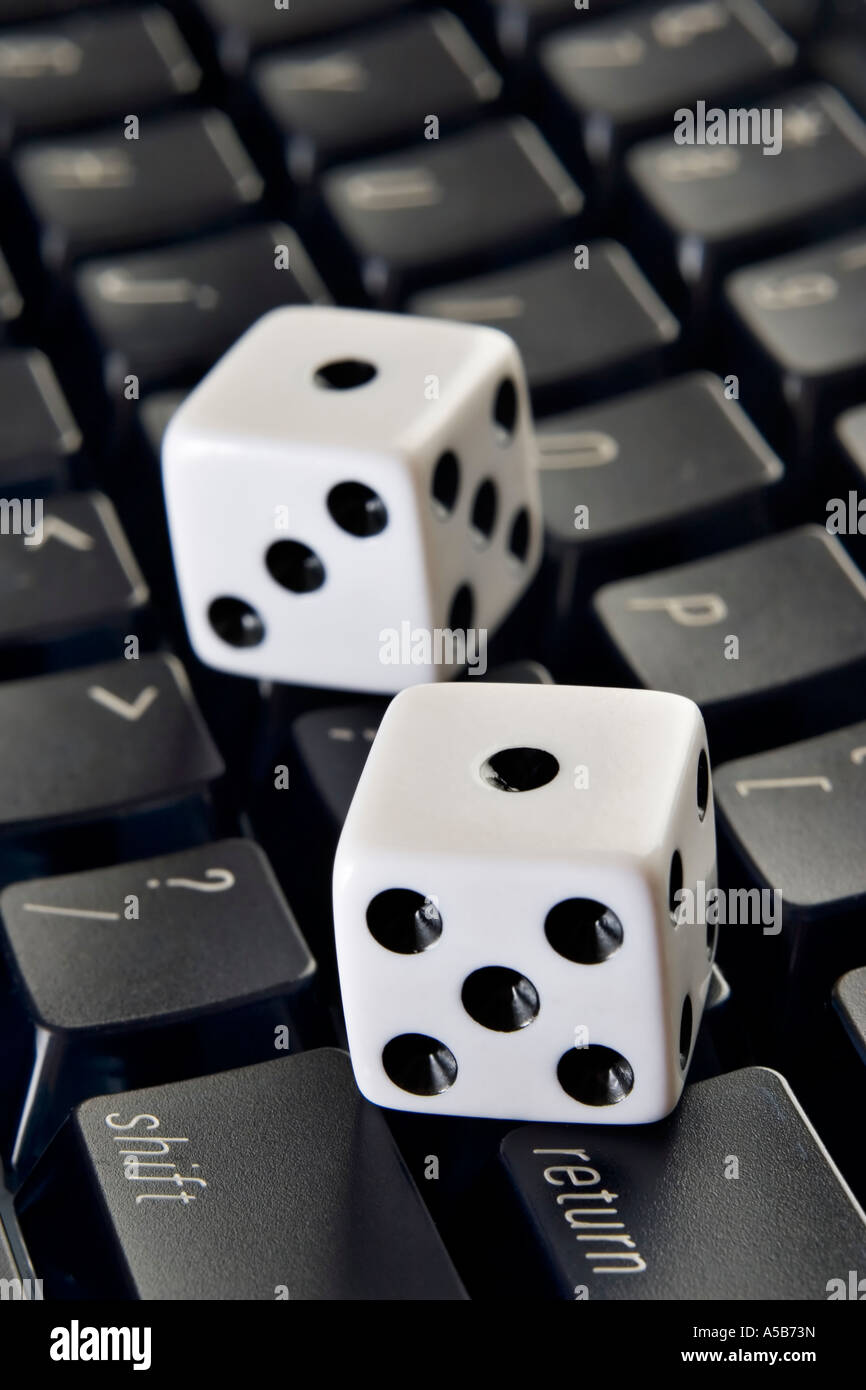 Dice rolled snake eyes on a computer keyboard Stock Photo - Alamy