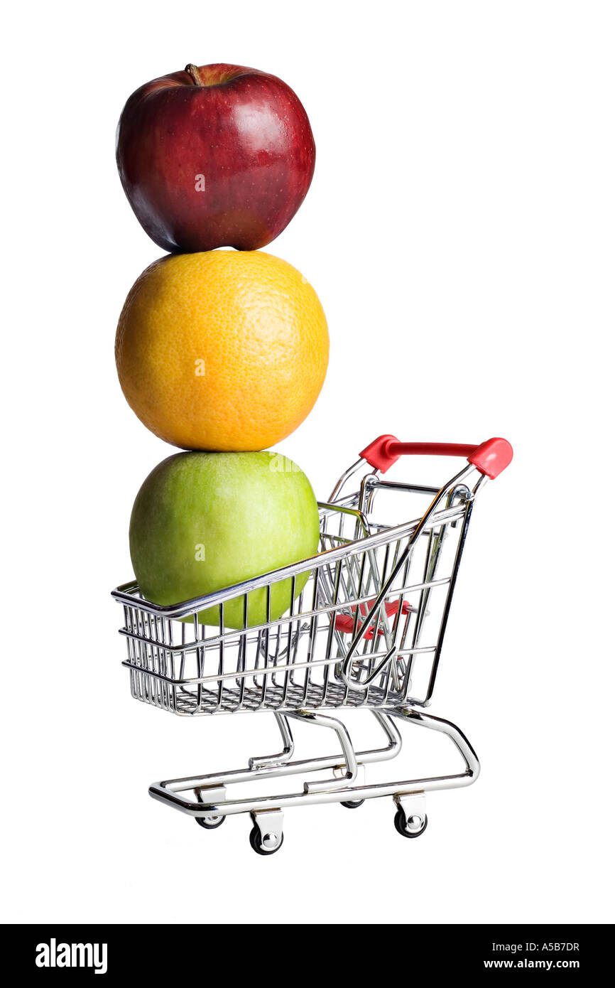 Apples and an orange in a miniature shopping cart on white Stock Photo ...
