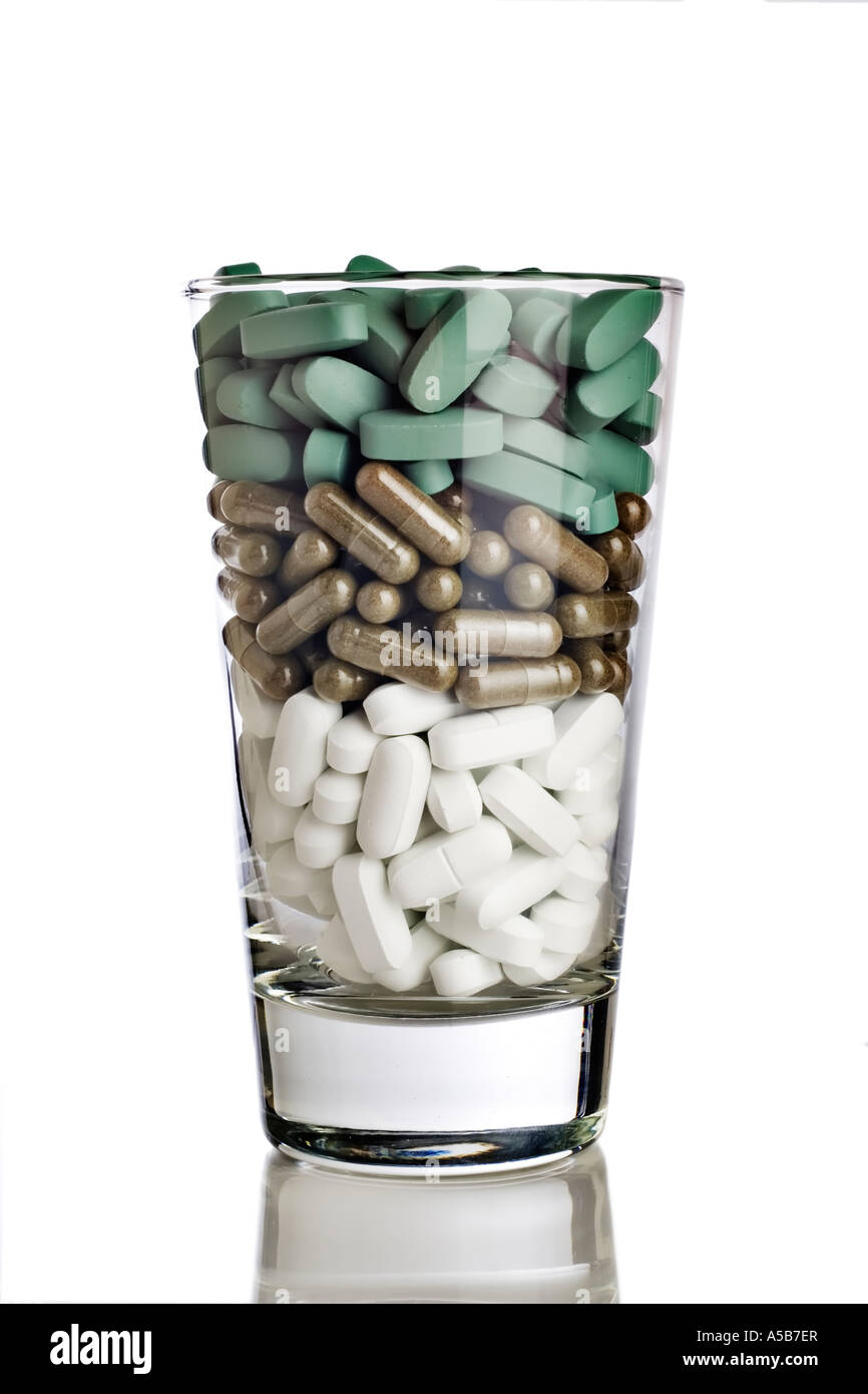 Glass full of different color vitamins Stock Photo - Alamy