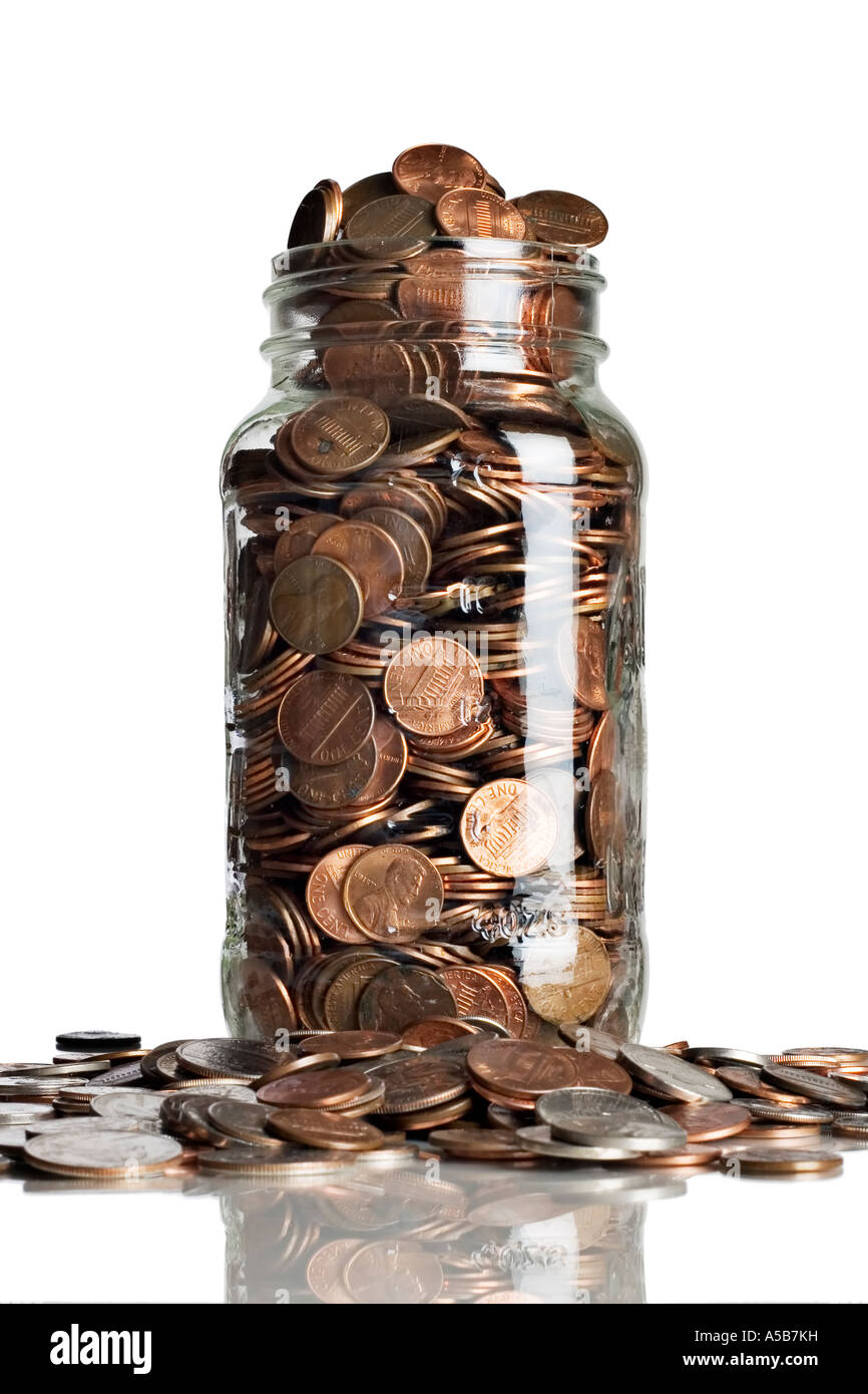 Jar of pennies overflowing Stock Photo - Alamy