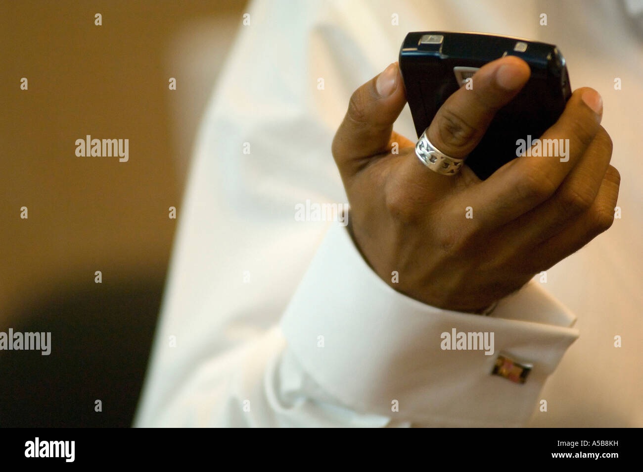 Business man using his PDA in the office Stock Photo - Alamy