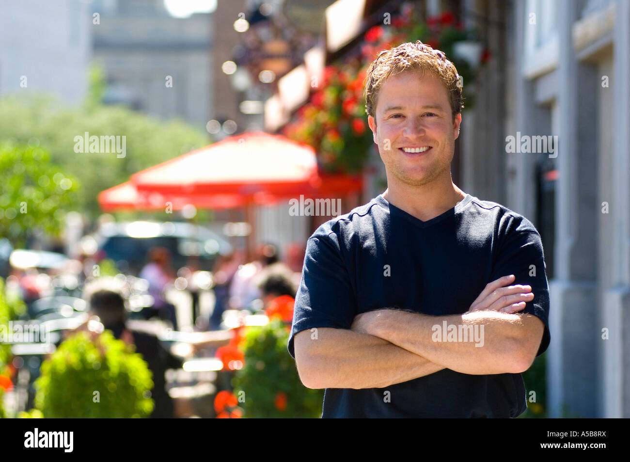 Proud man standing in front of outdoor cafe Stock Photo - Alamy