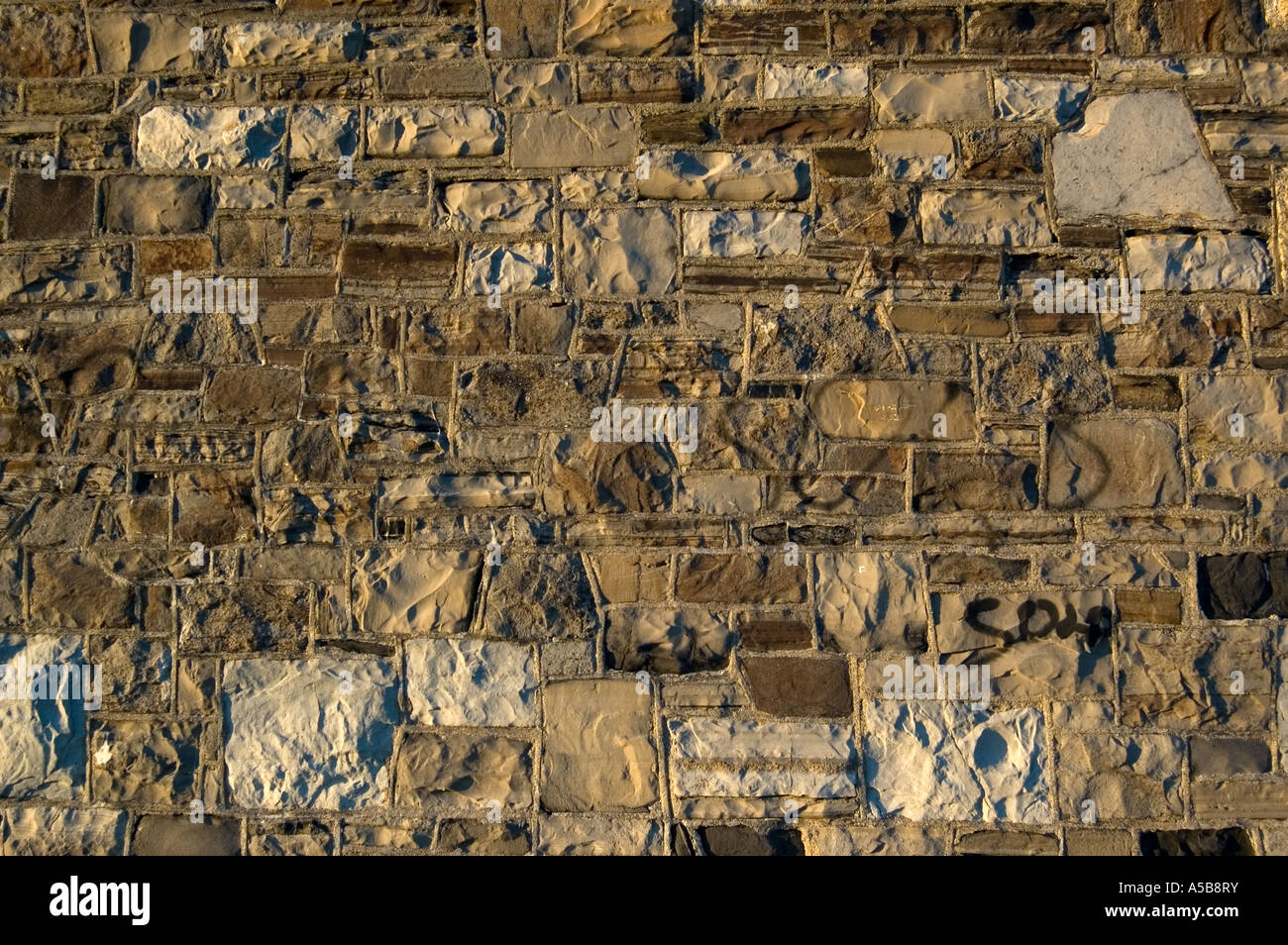 sunlit stone wall, mix of limestone, sandstone, granite, Ideal as a ...