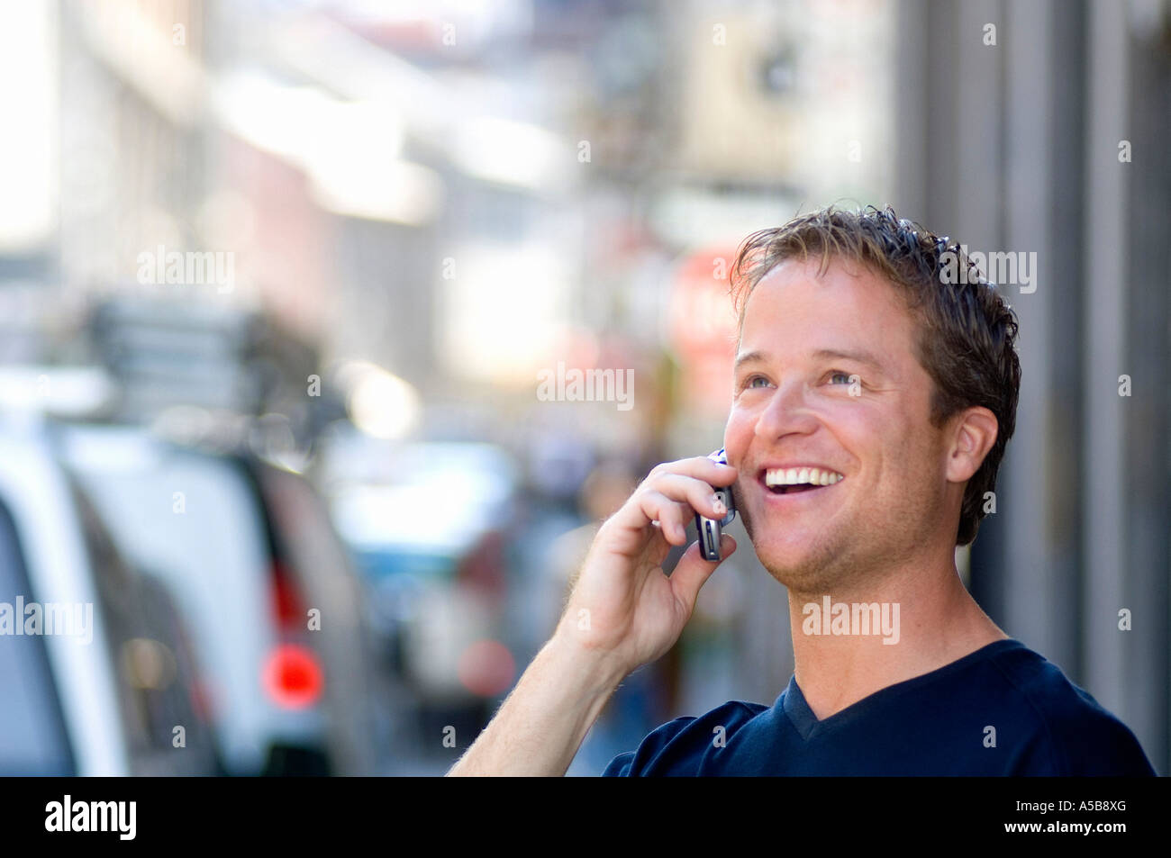 Very happy man talking his cellular phone Stock Photo - Alamy
