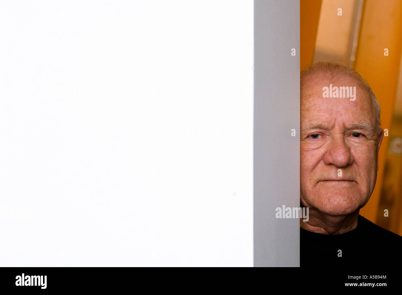 Old man hiding around corner of wall Stock Photo - Alamy