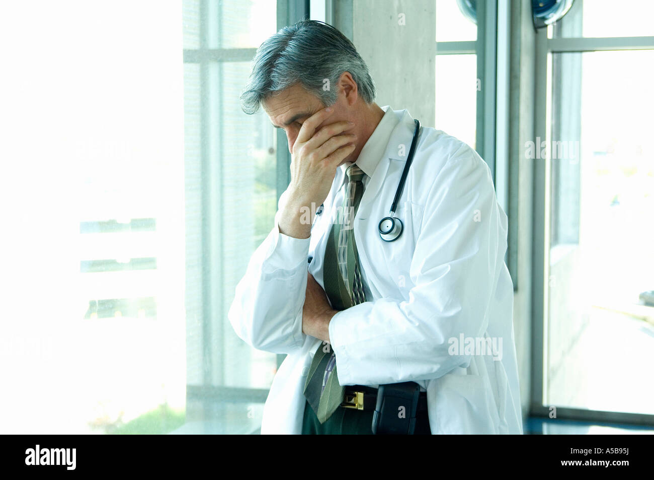 Doctor having a personal moment of sadness Stock Photo - Alamy