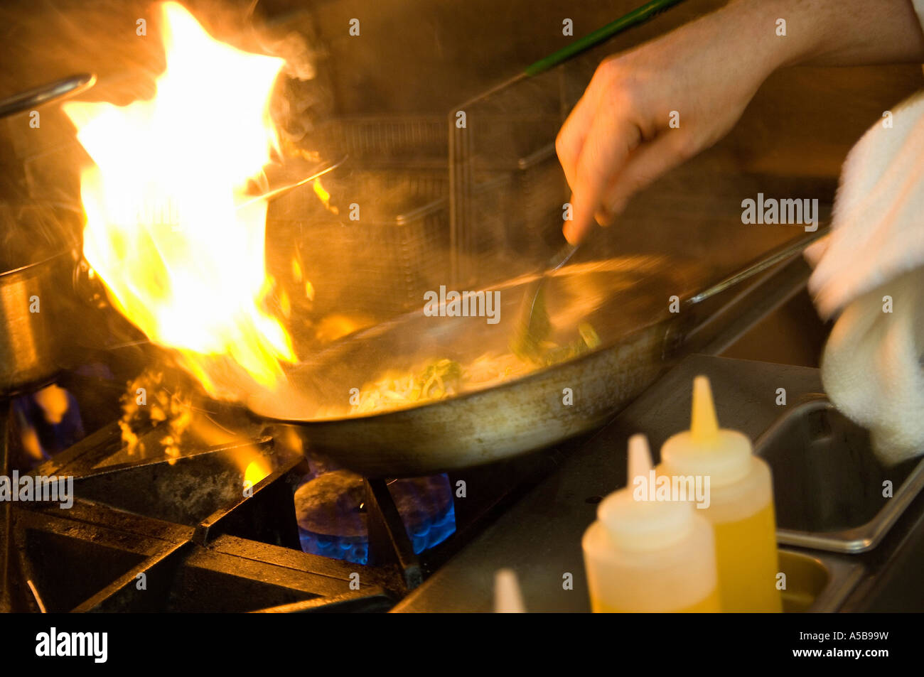 Chef cooking with a flaming pan Stock Photo - Alamy