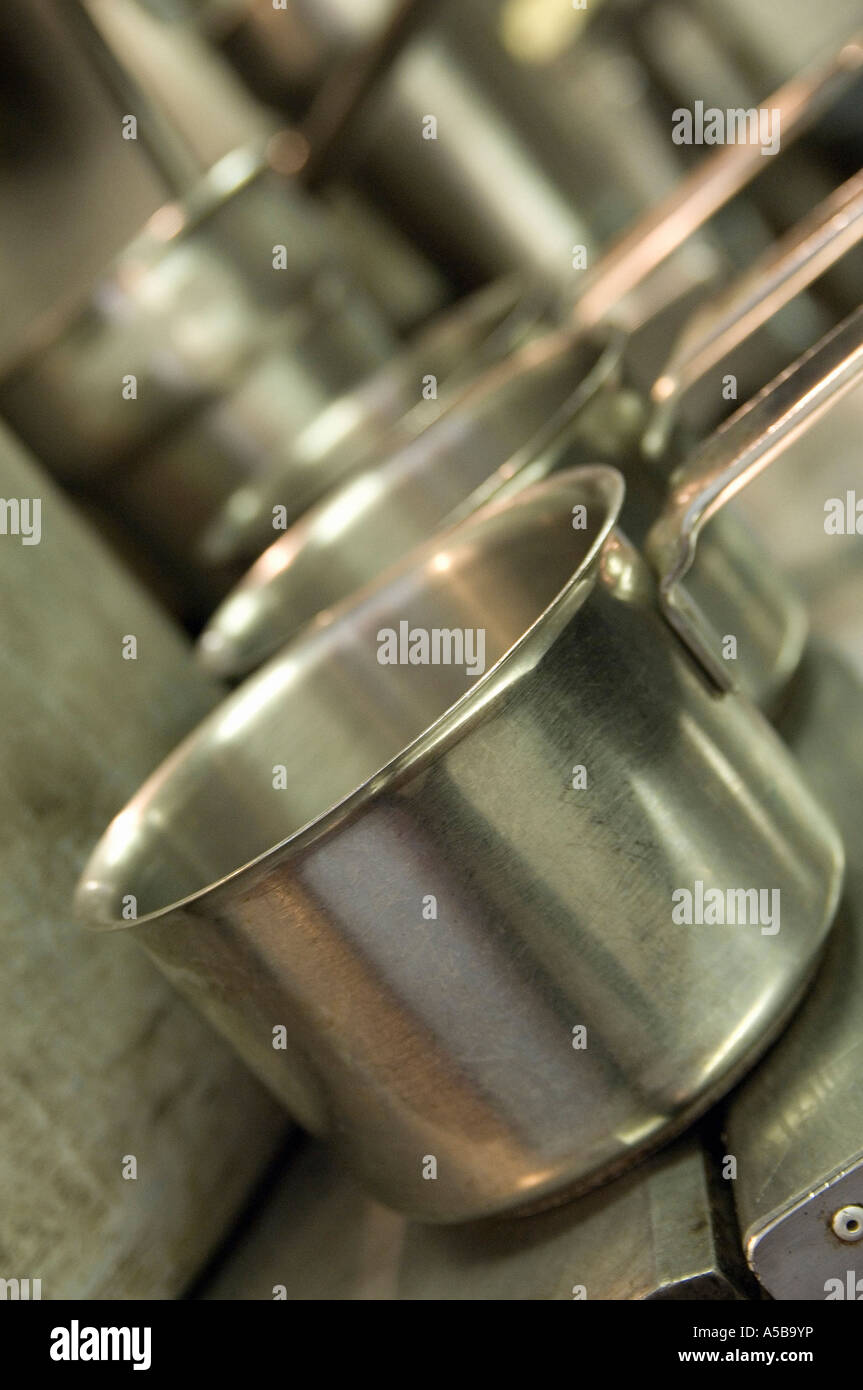 Several steel cooking pots in gourmet kitchen Stock Photo - Alamy