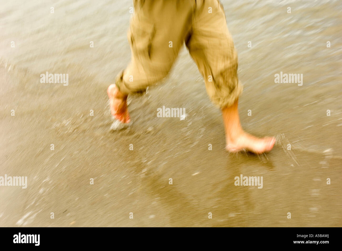 Man walking quickly through water Stock Photo - Alamy
