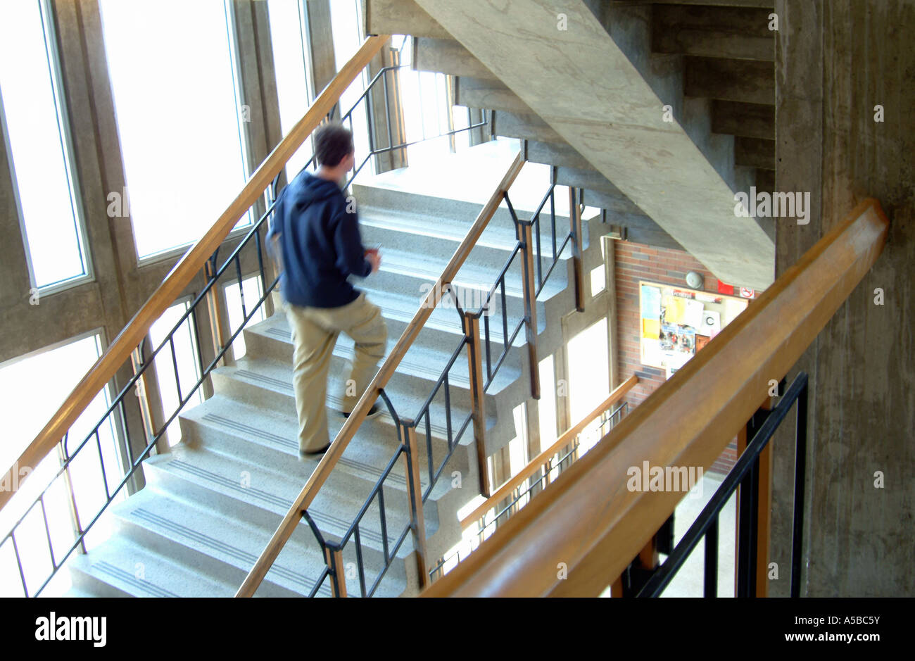 College student climbing stairs Stock Photo - Alamy