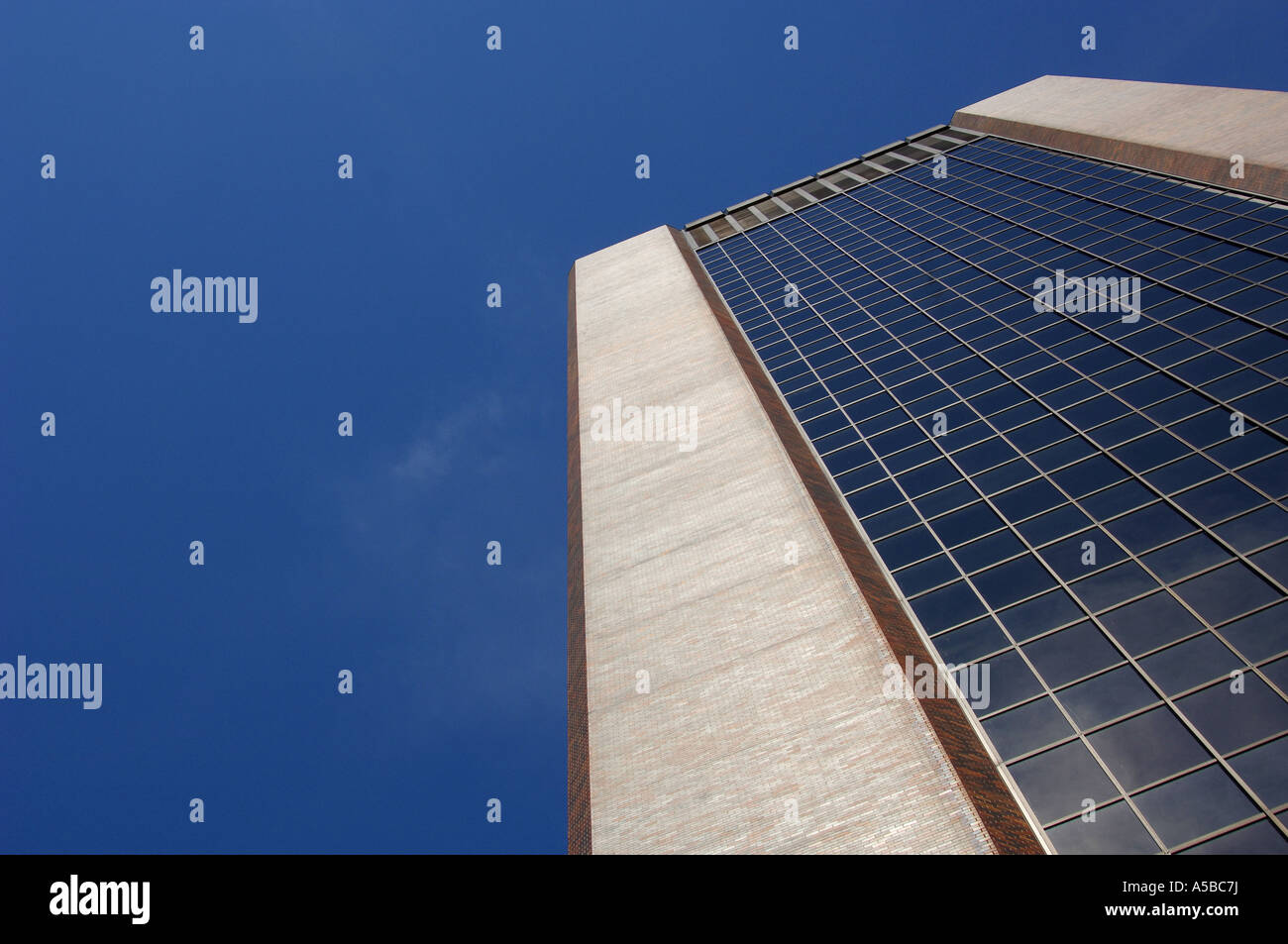 Tall office building with blue sky background Stock Photo - Alamy