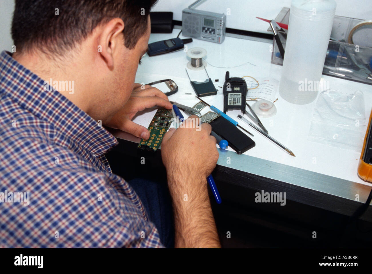 Men at work in a mobile phone repair shop Beirut Stock Photo - Alamy