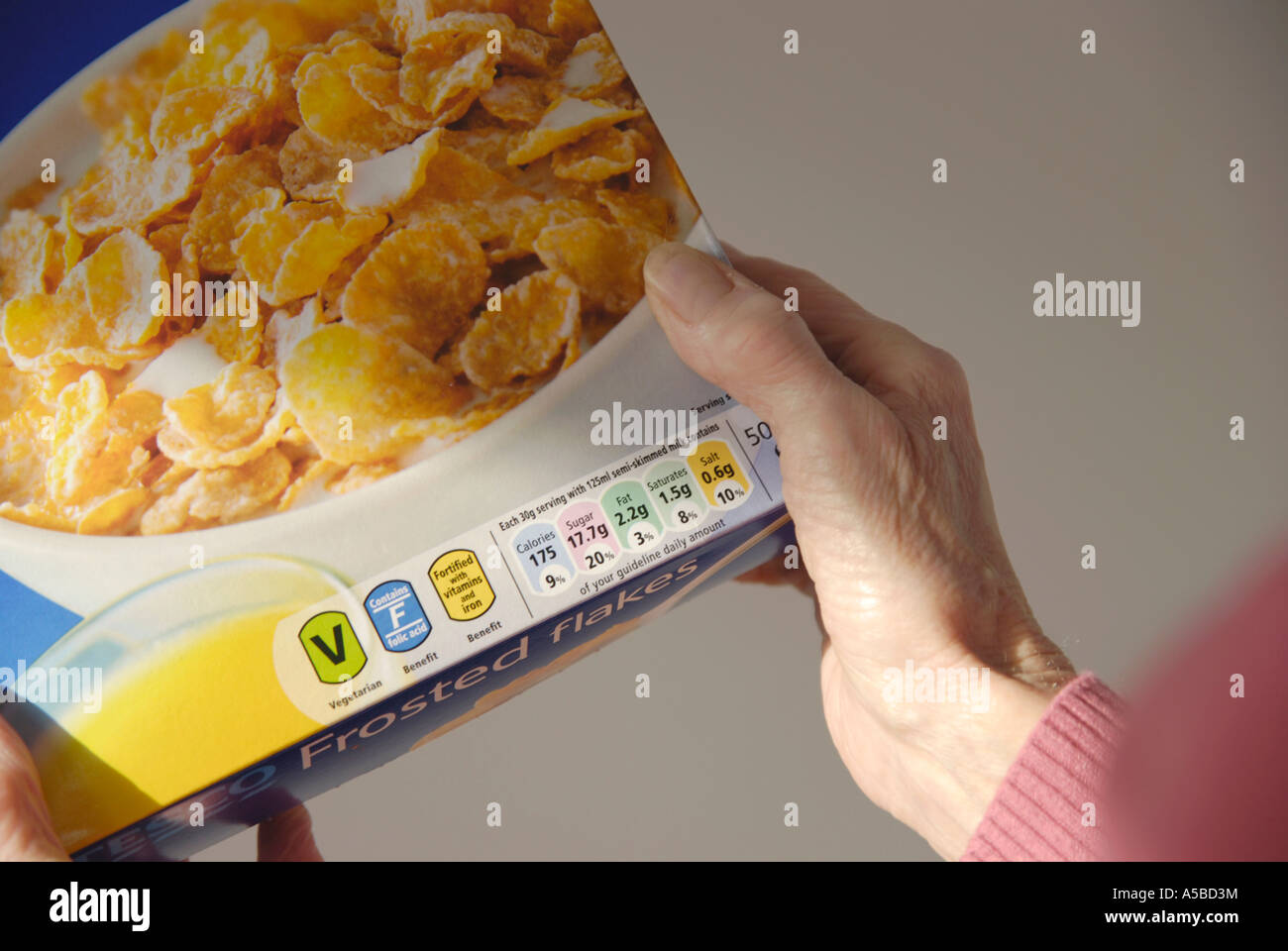 looking at packet of breakfast cereal nutritional information values ...