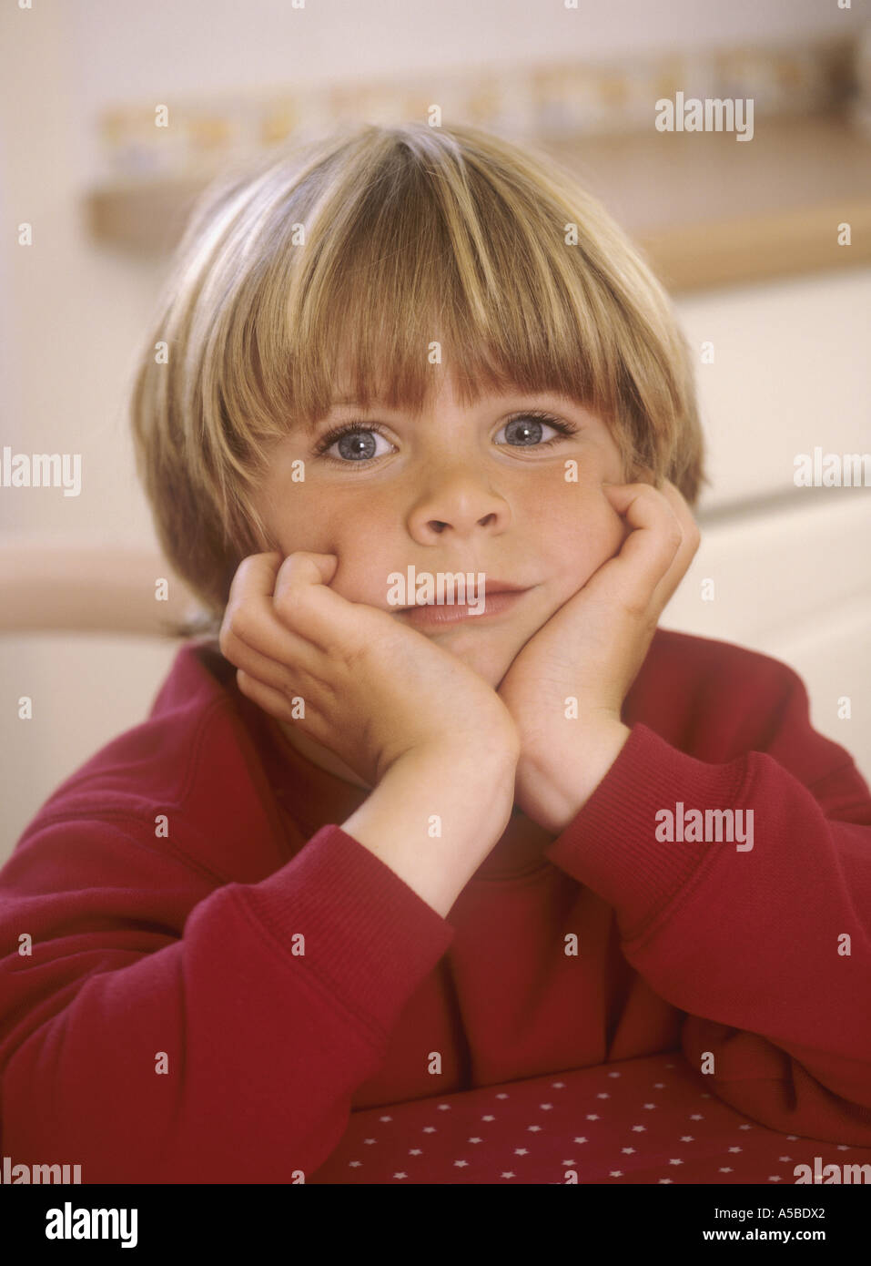Portrait of young boy looking fed up and bored Stock Photo - Alamy