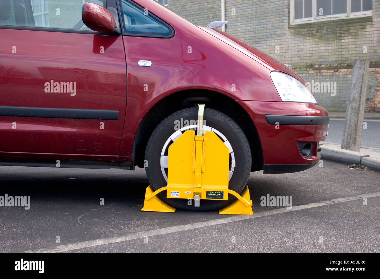Car with wheel clamp on it Stock Photo - Alamy