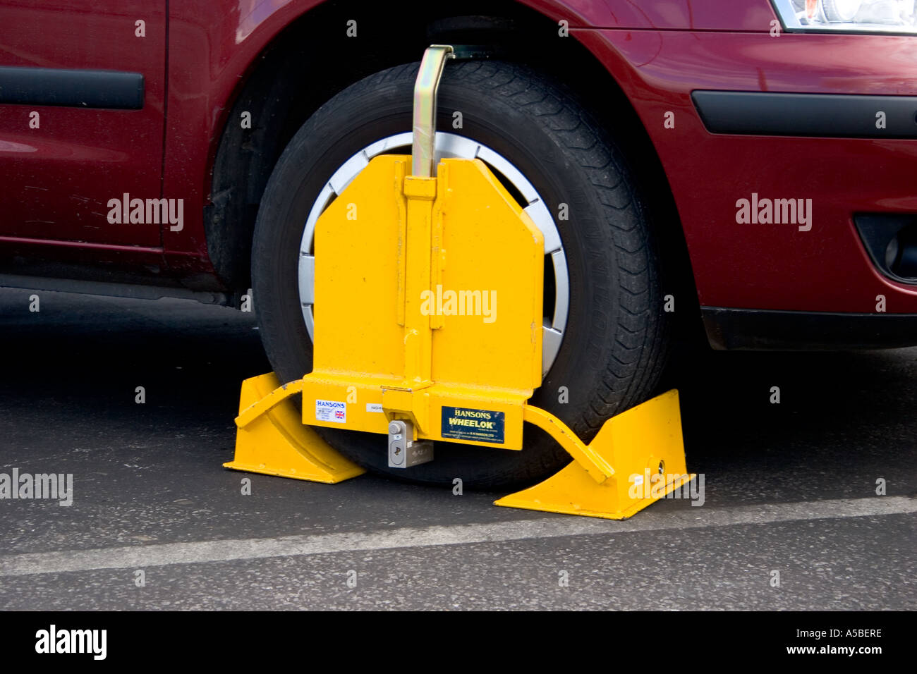 Car with wheel clamp on it Stock Photo - Alamy