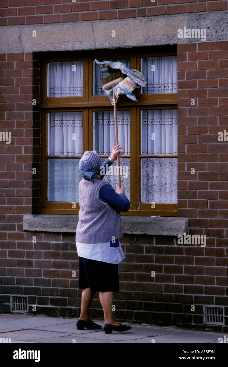 WOMAN WASHING WINDOWS EASINGTON COUNTY DURHAM ENGLAND Stock Photo - Alamy