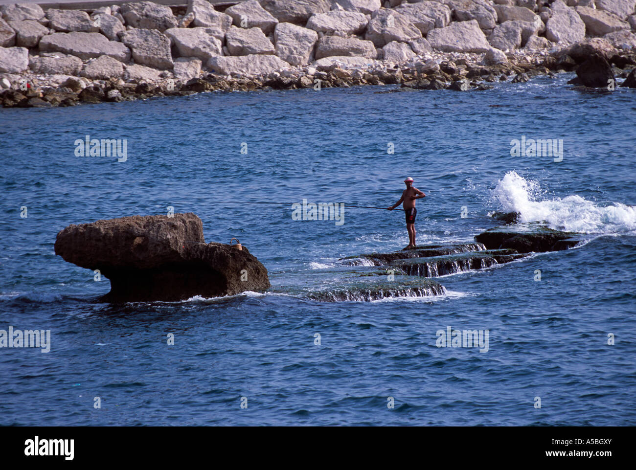 Man fishing on rock, Beirut, Lebanon Stock Photo - Alamy